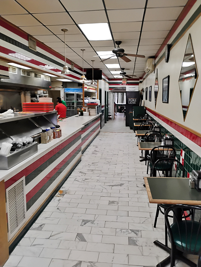 Step inside and the classic red, white, and green color scheme announces you've found authentic Italian-American pizza territory. No frills, just thrills.