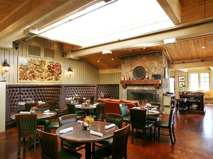 Leather booths, wooden beams, and a stone fireplace create that perfect "upscale lodge" vibe where comfort meets class.