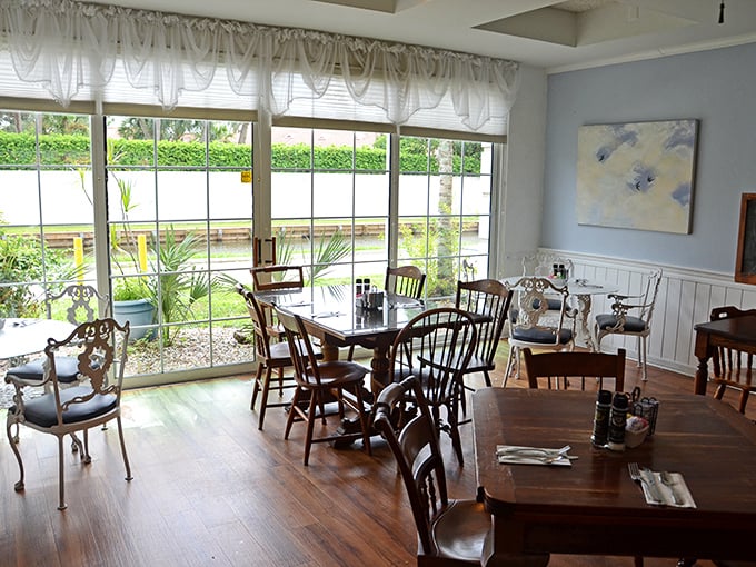 Sunlight streams through windows onto wooden tables where breakfast dreams come true. The dining room feels like your favorite aunt's Florida sunroom.