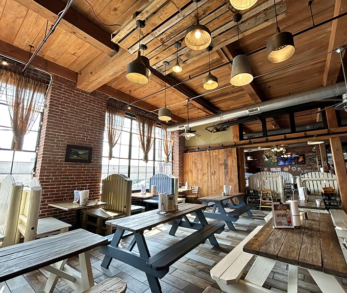 Wooden picnic tables beneath exposed beams create that perfect "come as you are" vibe where strangers become friends over shared BBQ enthusiasm.