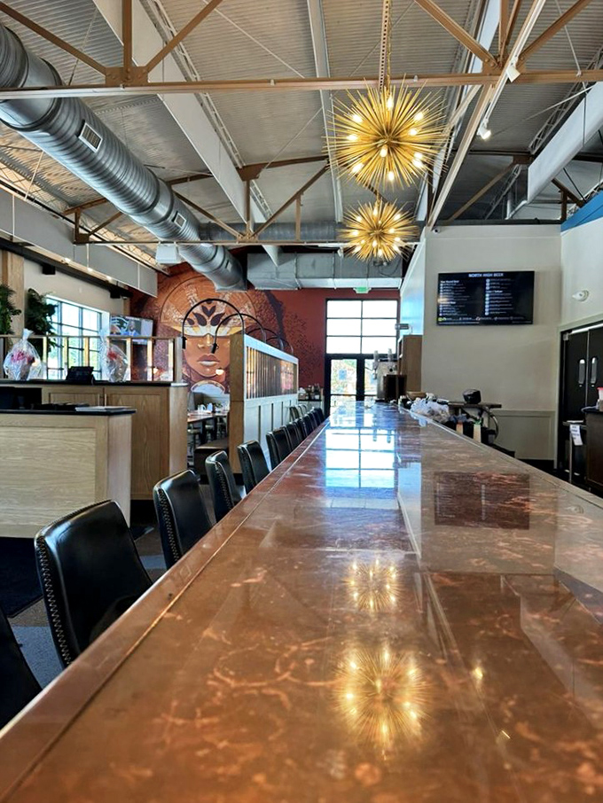 Industrial chic meets warm hospitality under those spectacular starburst chandeliers. That copper bar isn't just gorgeous&mdash;it's the stage for brewing magic.