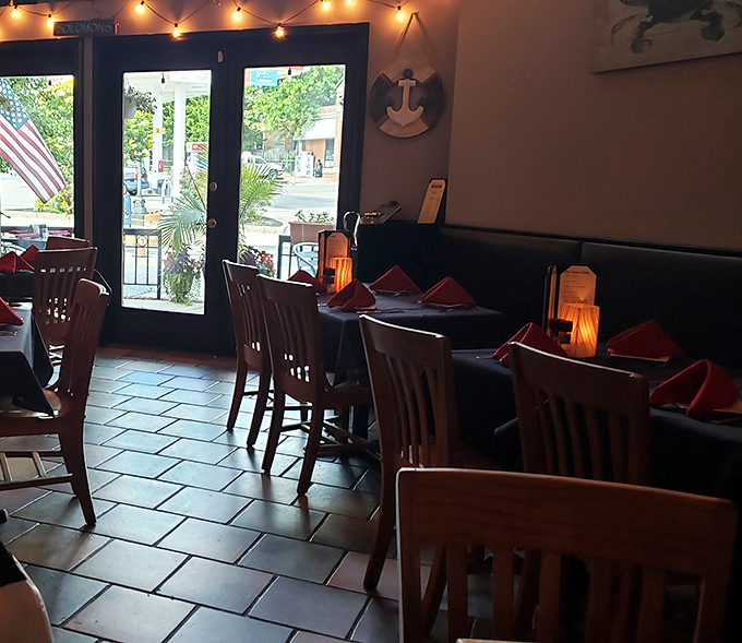 String lights cast a warm glow over wooden chairs and coral napkins&mdash;the perfect backdrop for seafood stories and second rounds.