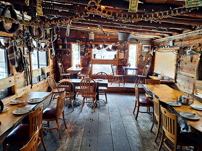 Step inside and time travel begins. Authentic ranch tools hang from rough-hewn beams, creating an atmosphere no designer could replicate if they tried.