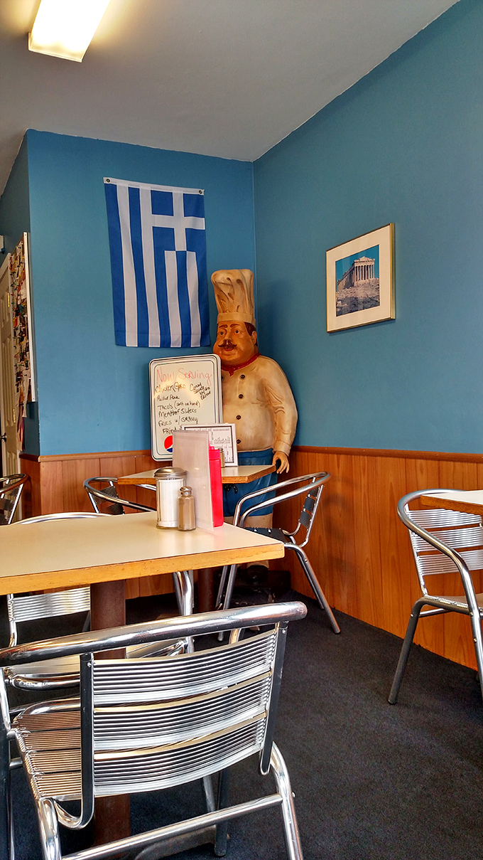 Blue walls, a Greek flag, and a chef statue standing guard – this little corner of Greece in Ohio feels like a Mediterranean escape.