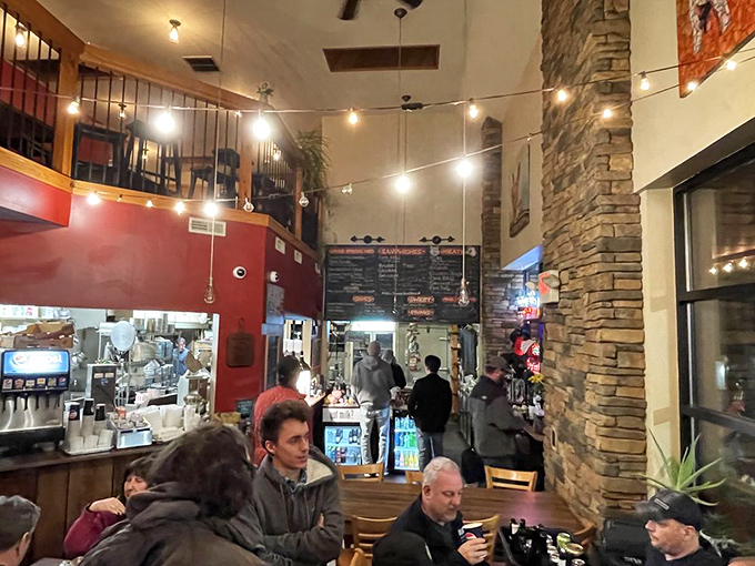 String lights dance overhead while stone walls create a rustic-meets-cozy vibe &ndash; the perfect backdrop for the serious business of barbecue appreciation.