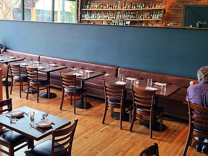 Warm wooden floors meet leather banquettes in this dining room where conversations flow as smoothly as the Argentine wines.