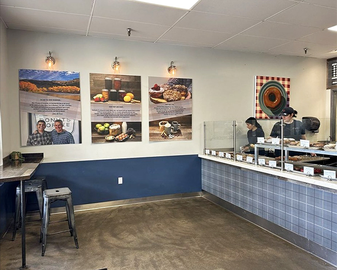 Minimalist charm with maximum donut potential. The blue-tiled counter and rustic metal stools create the perfect stage for impending sugar bliss.