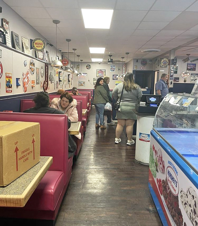 Classic red vinyl booths and walls adorned with automotive memorabilia create the perfect backdrop for breakfast conversations that flow as smoothly as their coffee.
