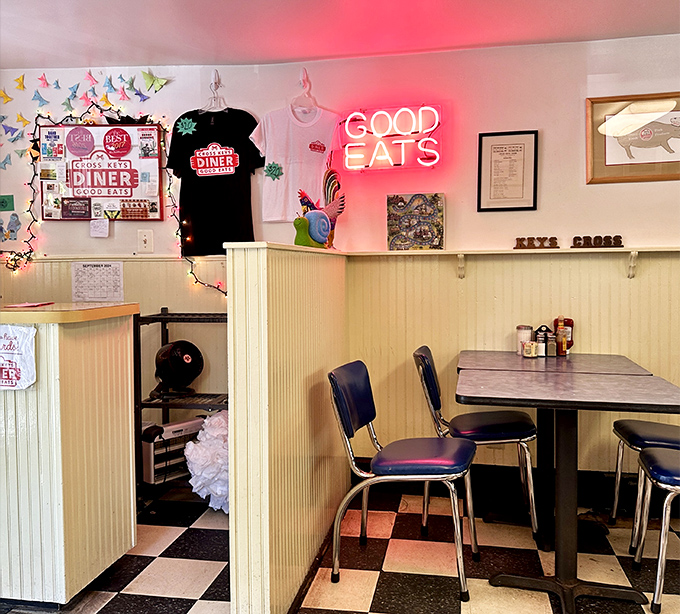 Retro vibes and a neon "GOOD EATS" sign that doesn't lie. This classic black-and-white checkered floor has witnessed countless breakfast epiphanies.