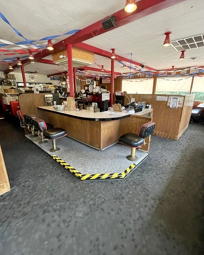 Classic diner counter seating where strangers become friends and calories don't count. Those red pillars have witnessed countless food epiphanies.