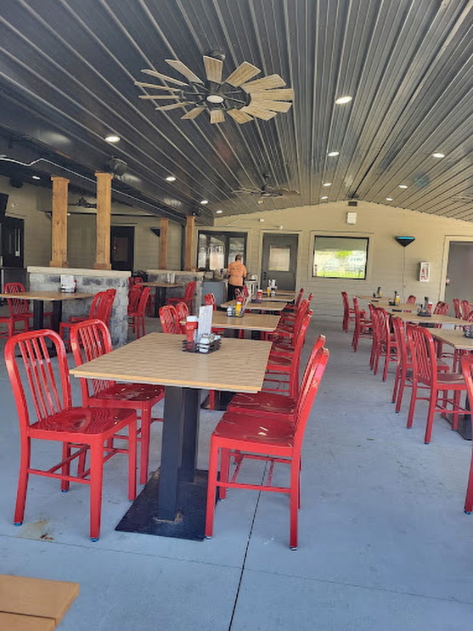 Inside, bright red chairs pop against metal ceiling panels, creating a space that's both industrial-chic and warmly inviting.