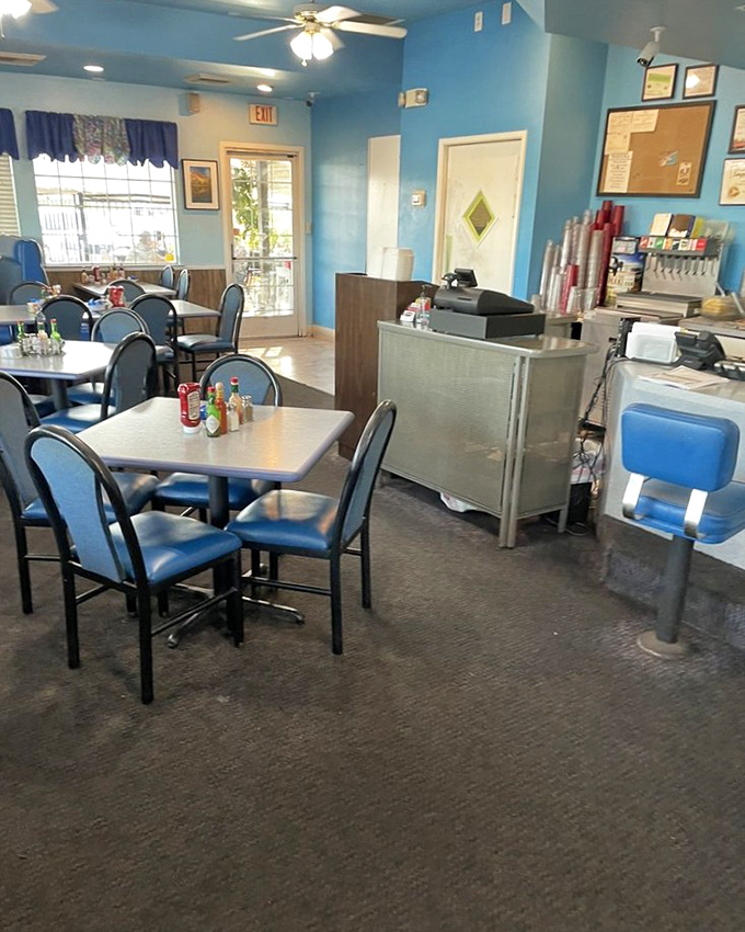 Blue walls and cozy tables create that classic diner atmosphere where memories are made and diet plans go to die. Worth every delicious calorie!