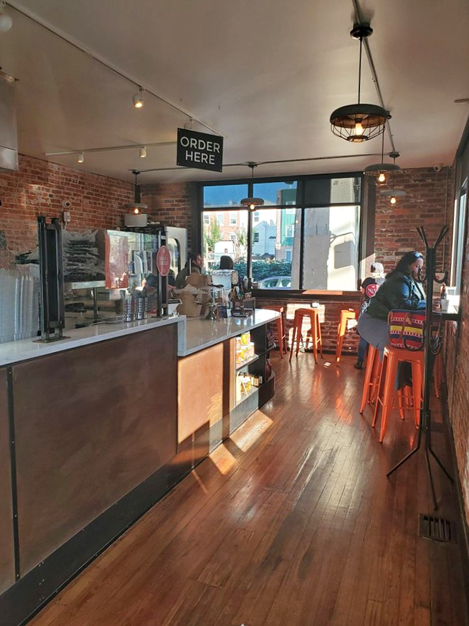 Step inside this cozy haven where exposed brick meets modern comfort, creating the perfect fried chicken sanctuary.