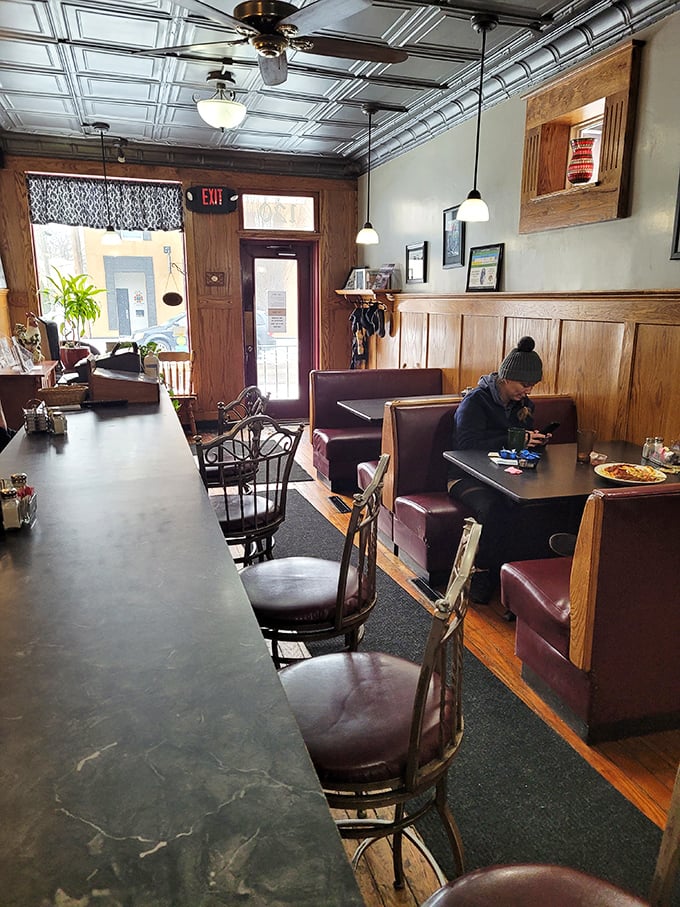 Step inside and time slows down. The pressed tin ceiling, wooden wainscoting, and burgundy booths aren't trying to be retro&mdash;they simply never left.