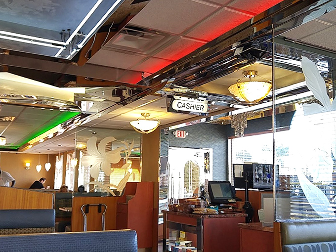 Inside, chrome meets comfort under the warm glow of pendant lights. The cashier sign might as well say "Happiness Dispensed Here."