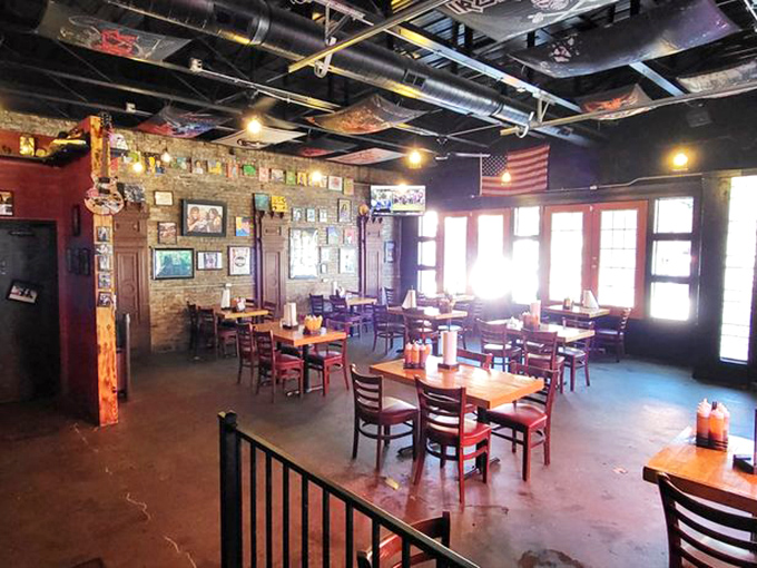 Industrial chic meets barbecue comfort in this dining room where exposed pipes and brick walls create the perfect backdrop for meat-induced euphoria.