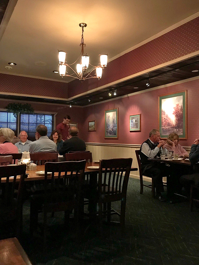The dining room's burgundy walls and warm lighting create that rare atmosphere where conversations flow easily and everyone looks their best. Classic steakhouse ambiance done right.