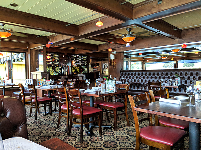 Rich wooden beams, leather booths, and patterned carpets create that perfect sweet spot between "fancy night out" and "comfortable enough to audibly appreciate your food."