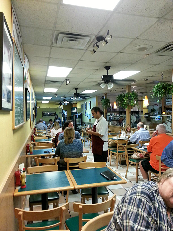 No fancy design firm needed here – just wooden chairs, ceiling fans, and servers who know regulars by name. This is where food matters more than frills.