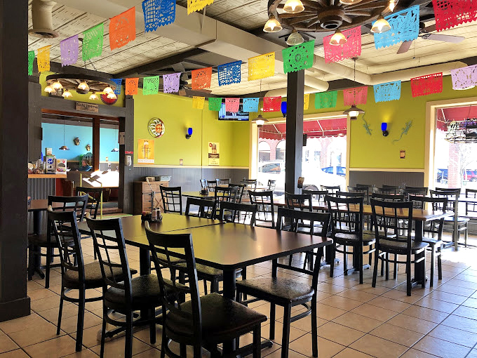 Those burgundy booths have heard more stories than a bartender on New Year's Eve.