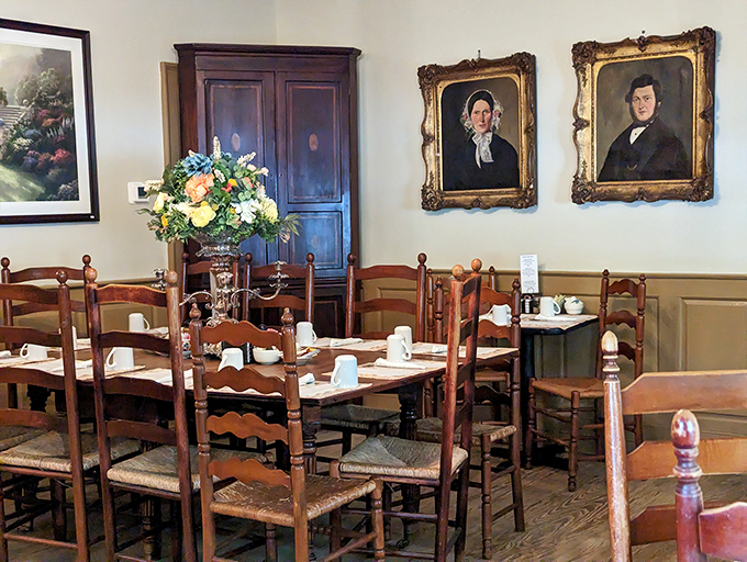 History watches over your meal from gold-framed portraits, while ladder-back chairs and fresh flowers create the perfect setting for comfort food revelations.