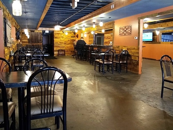 Industrial chic meets comfort food haven. The metallic walls and American flag create the perfect no-nonsense backdrop for serious eating.