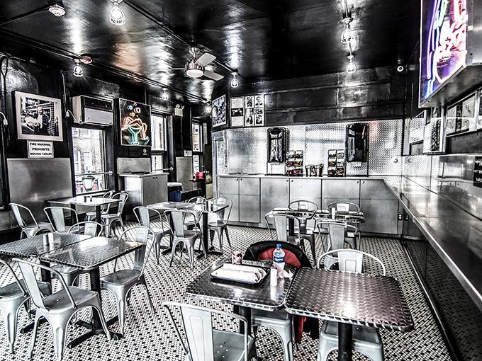 Industrial chic meets sandwich shrine in Jim's dining area, where metal tables and chairs have witnessed countless "first bite" moments of cheesesteak bliss.