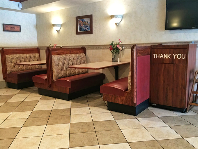 Classic red vinyl booths that have witnessed countless family dinners. This no-frills dining room prioritizes comfort over trendiness—exactly as a neighborhood pizza joint should.