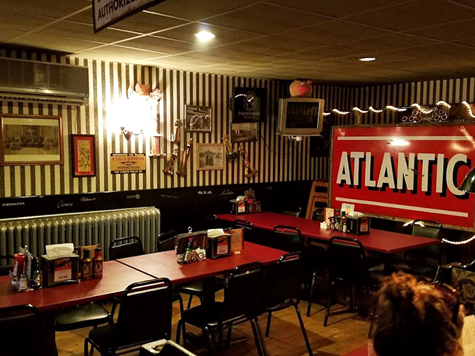 Step inside and you're transported to barbecue nirvana—black and white striped wallpaper, vintage signs, and that iconic Atlantic advertisement creating the perfect backdrop for meat-induced euphoria.