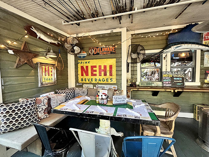 Vintage signs and mismatched furniture create that "your cool uncle's fishing cabin" vibe that makes every meal feel like a mini-vacation.
