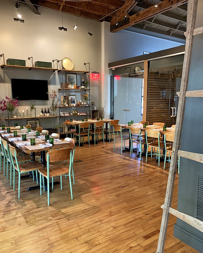Rustic wooden beams meet mint-green chairs in a dining room that feels both farmhouse-authentic and Instagram-ready. Nonna would approve.