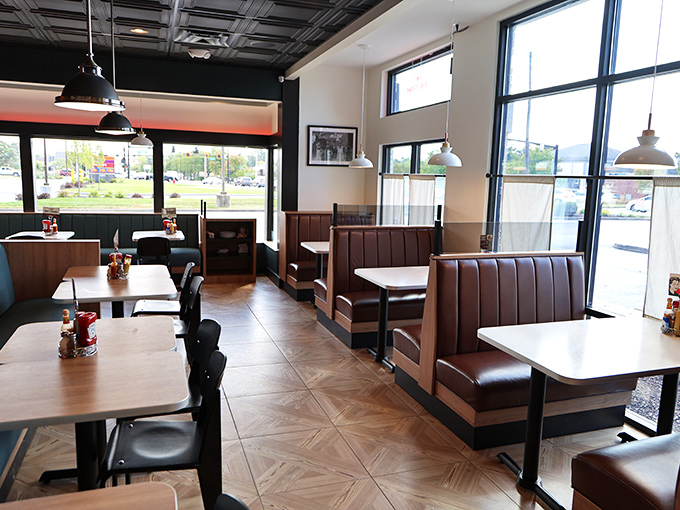 Brown leather booths invite lingering conversations while natural light pours through windows, creating the perfect backdrop for comfort food indulgence.