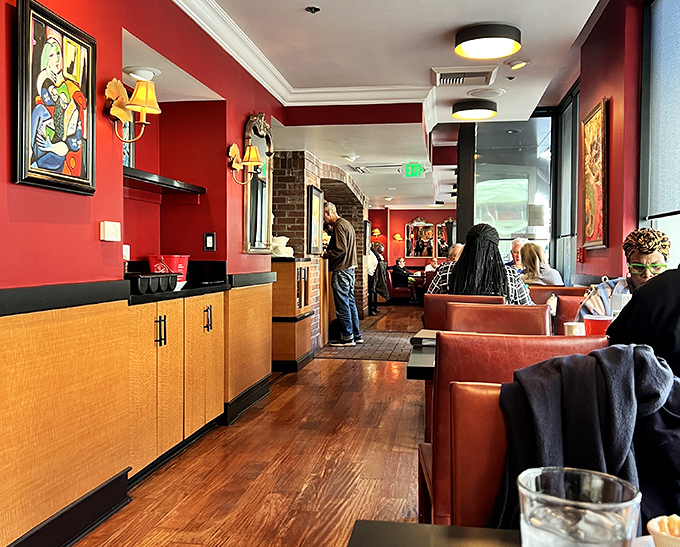 Rich red walls and leather booths create the perfect backdrop for morning conversations that flow as smoothly as the coffee refills.