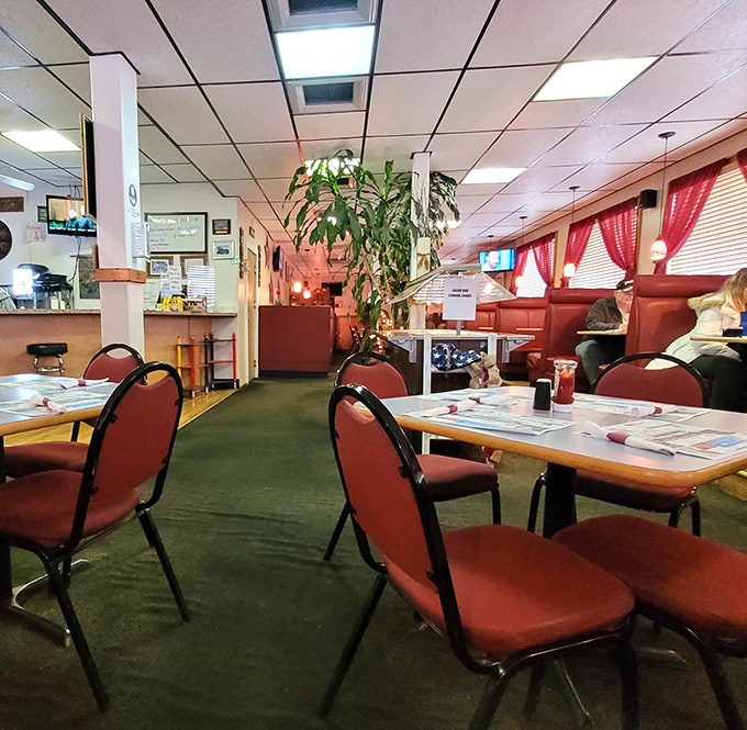 Inside, red booths and green carpeting create a homey atmosphere where conversations flow as freely as the coffee refills.