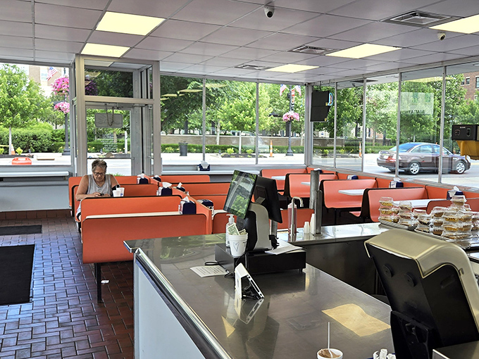 Bright orange booths and abundant natural light create the perfect backdrop for burger bliss&mdash;no Instagram filter required.