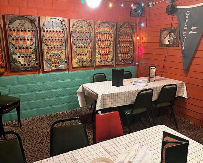 Inside, vintage pinball backglasses transform dining walls into a museum of Americana. The coral and turquoise color scheme shouldn't work, but somehow feels perfectly right.