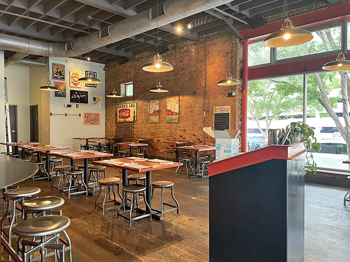 Industrial-chic meets Southern comfort in this airy space where exposed brick walls and pendant lighting create the perfect backdrop for culinary magic.