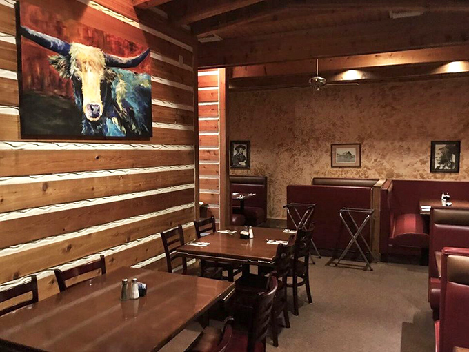 Log cabin walls meet cozy booths in this dining room where that steer painting isn't judging your order&mdash;he's jealous of what's about to land on your plate.