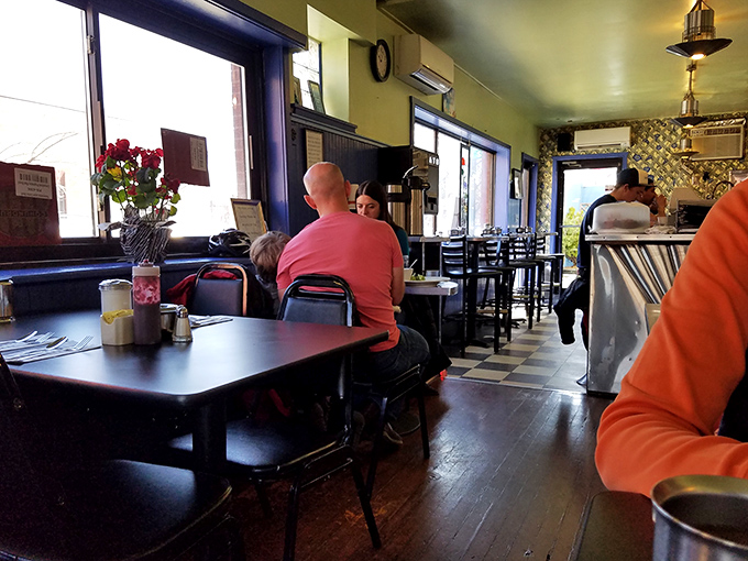 Inside, the classic diner vibe hits all the right notes: checkerboard floor, cozy booths, and that unmistakable buzz of happy conversations over coffee.