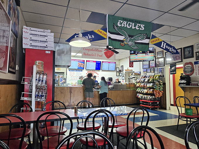 Inside, Philadelphia sports pride reigns supreme. Eagles flags flutter overhead while hungry patrons contemplate life's most important question: cheesesteak or hoagie?