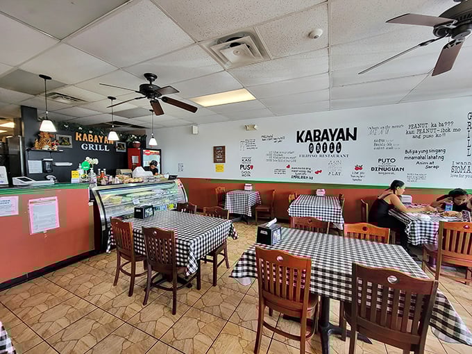 Classic black and white checkered tablecloths set the stage for culinary drama where the real stars are the authentic Filipino flavors.