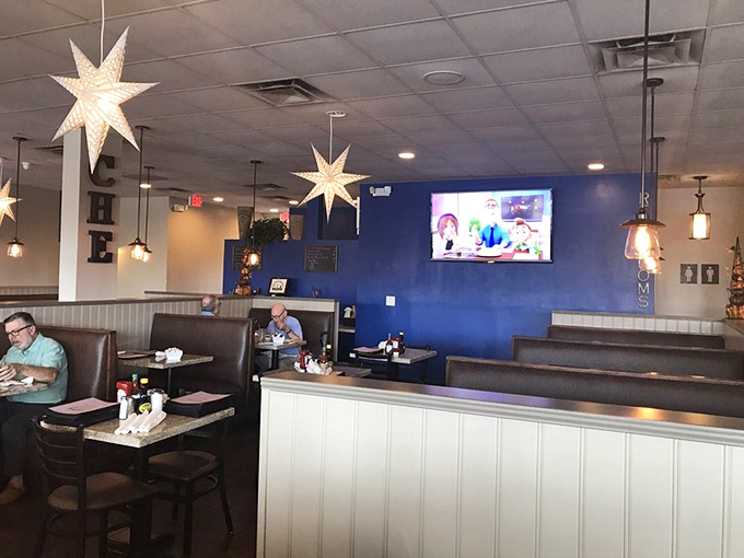 Blue walls and hanging star lights create a cozy diner atmosphere that says, "Stay awhile, the pancakes are worth it." No Instagram filter needed for genuine breakfast bliss.