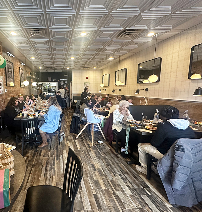 Inside, the warm wooden floors and distinctive ceiling tiles create an atmosphere that feels like dining in someone's well-loved home rather than a restaurant.
