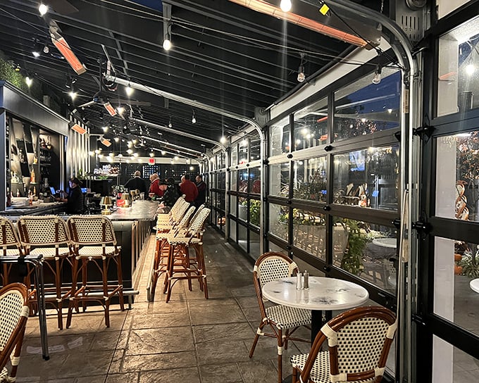 Inside, the elegant bar area beckons with bistro seating and ambient lighting. This isn't just dining&mdash;it's time travel with cocktails.