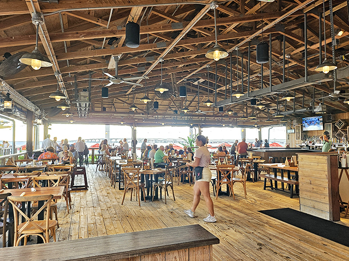 Rustic wooden beams stretch overhead like an upscale boat hull, while natural light floods the dining room—proof that "indoor seating" doesn't have to feel indoor at all.