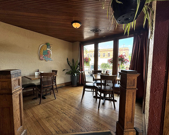 Wooden floors that creak with stories, hanging plants that breathe life, and windows that frame the neighborhood&mdash;this is comfort defined before you even taste the food.