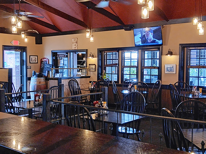 Exposed beams and warm lighting transform what was once a place of confinement into a cozy dining sanctuary where the only sentence is deliciousness.