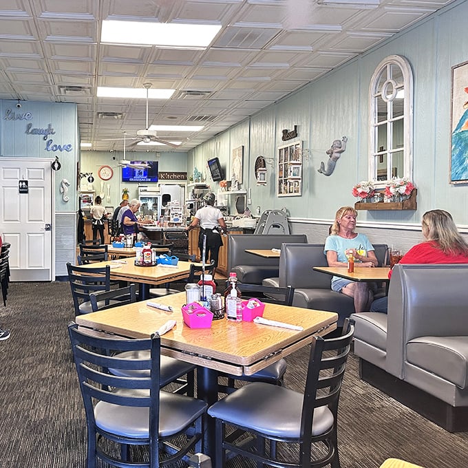 Inside, coastal blue walls and nautical accents create that perfect "Florida comfort" vibe—like if your favorite aunt's kitchen got a beachy makeover.