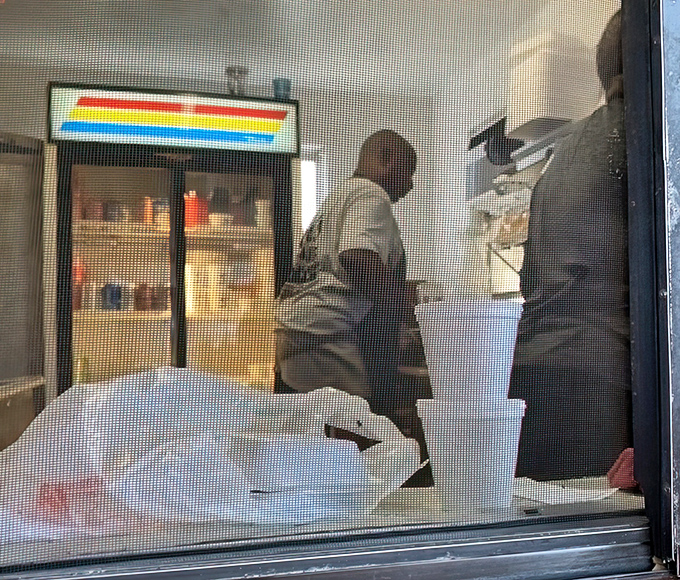 Behind the screen door, culinary magic happens. No frills, no fuss&mdash;just the serious business of barbecue perfection.