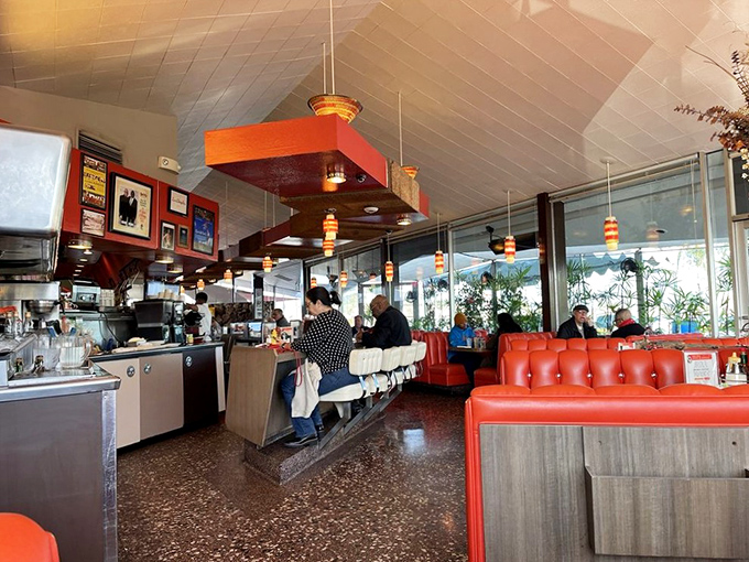 Inside, those iconic red vinyl booths and terrazzo floors transport you to a time when diners were social hubs and breakfast could cure anything.